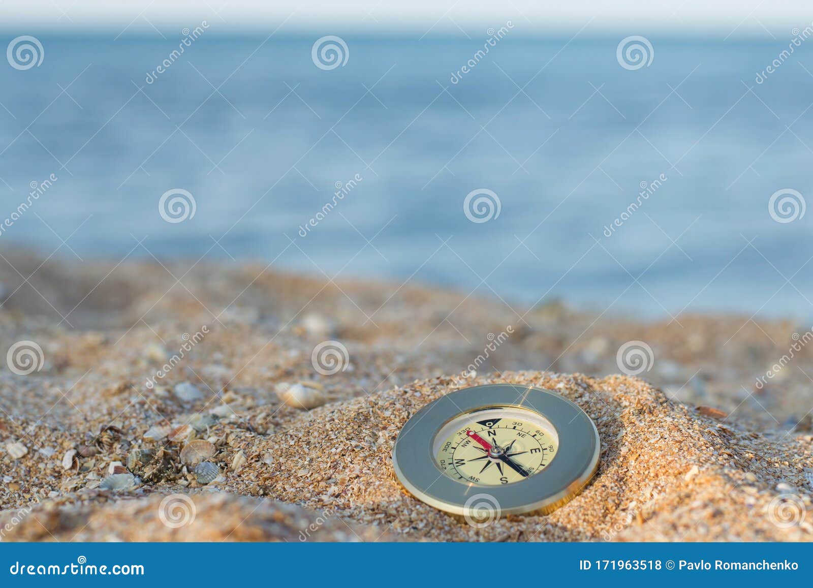 A Compass Showing the Direction Lies on the Sea Sand with Shells Stock ...