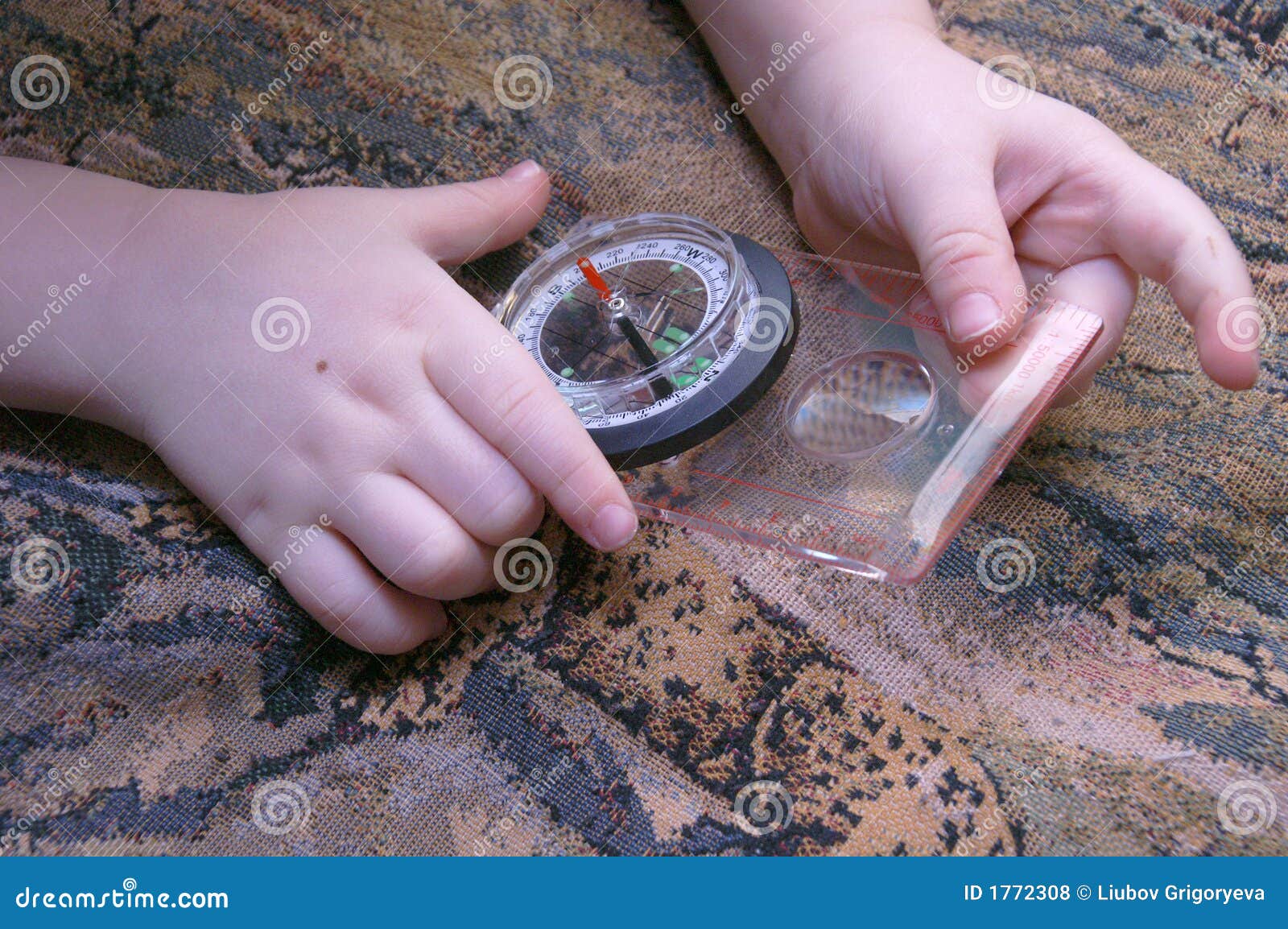 The Compass in the Two Little Hands Stock Photo - Image of directions ...