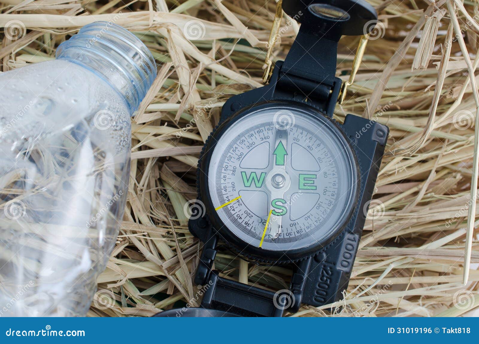 Compass with Water Bottle on the Hay Stock Photo - Image of compass ...