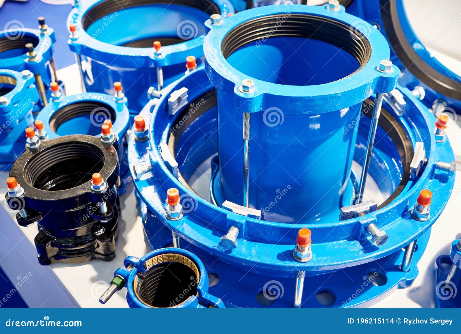 Coupling Flange. The Worker Tightens The Bolts On The Rubber Expansion ...