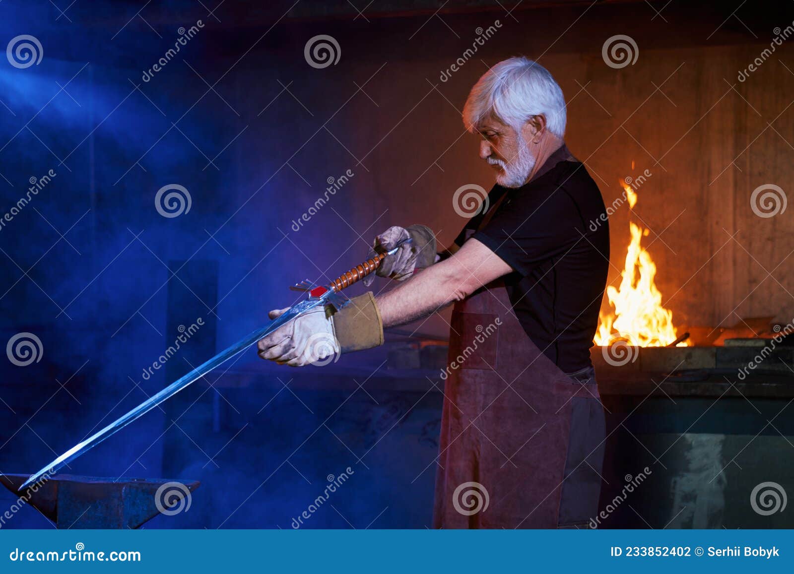 Competent Aged Blacksmith Making Sword at Forge Stock Photo - Image of ...