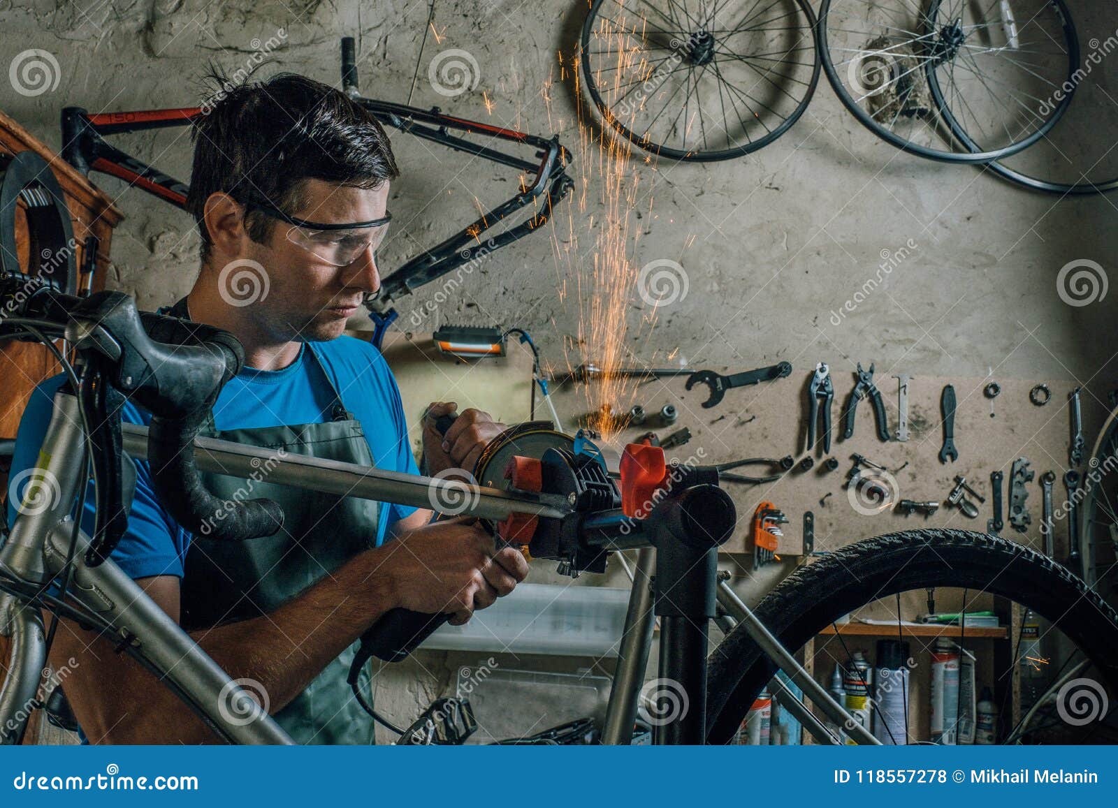 Competent Bicycle Mechanic in a Workshop Repairs a Bike. Stock Photo ...