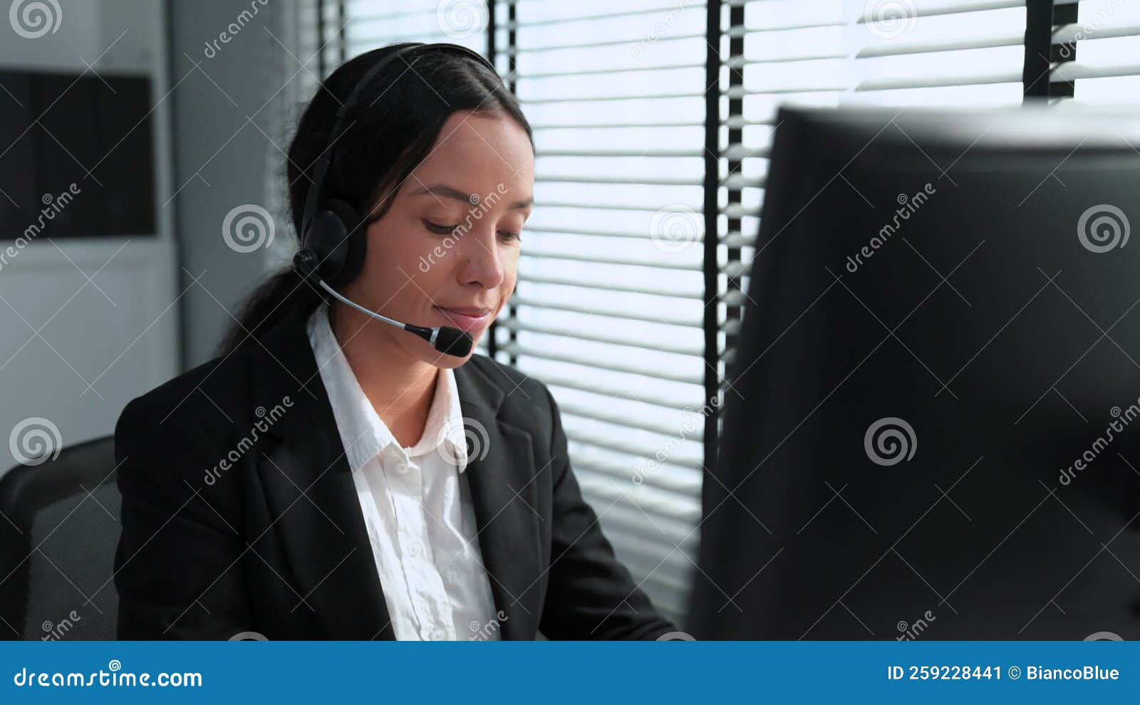 Competent Female Operator Working on Computer and while Talking with ...