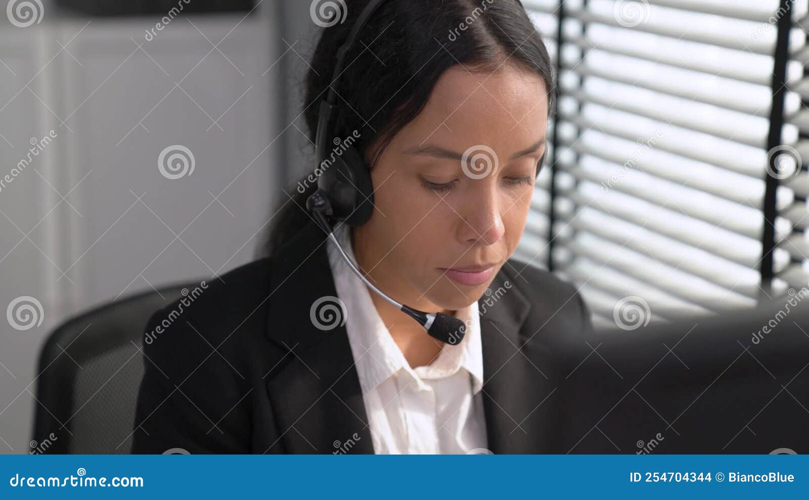 Competent Female Operator Working on Computer and while Talking with ...