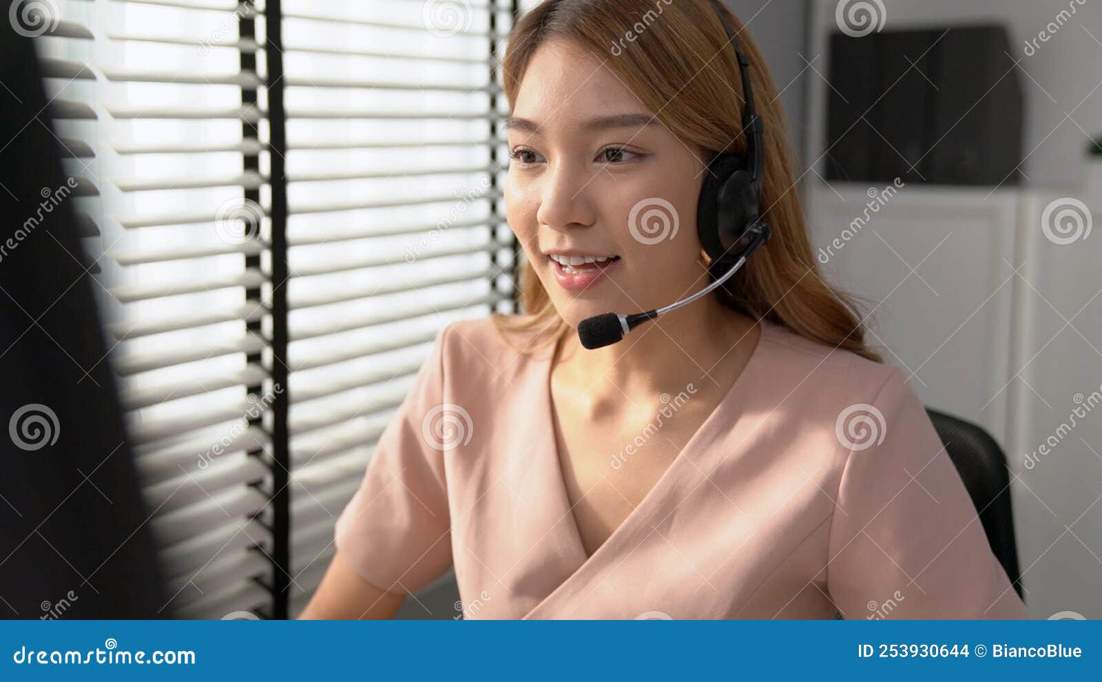 Competent Female Operator Working on Computer and while Talking with ...