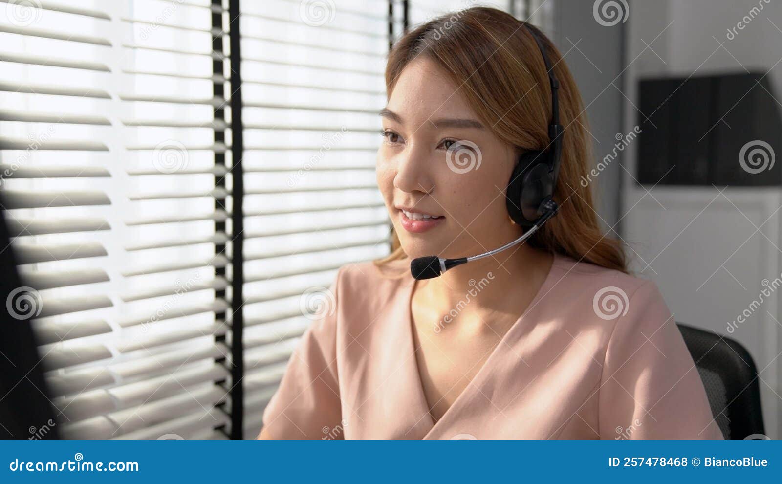 Competent Female Operator Working on Computer and while Talking with ...