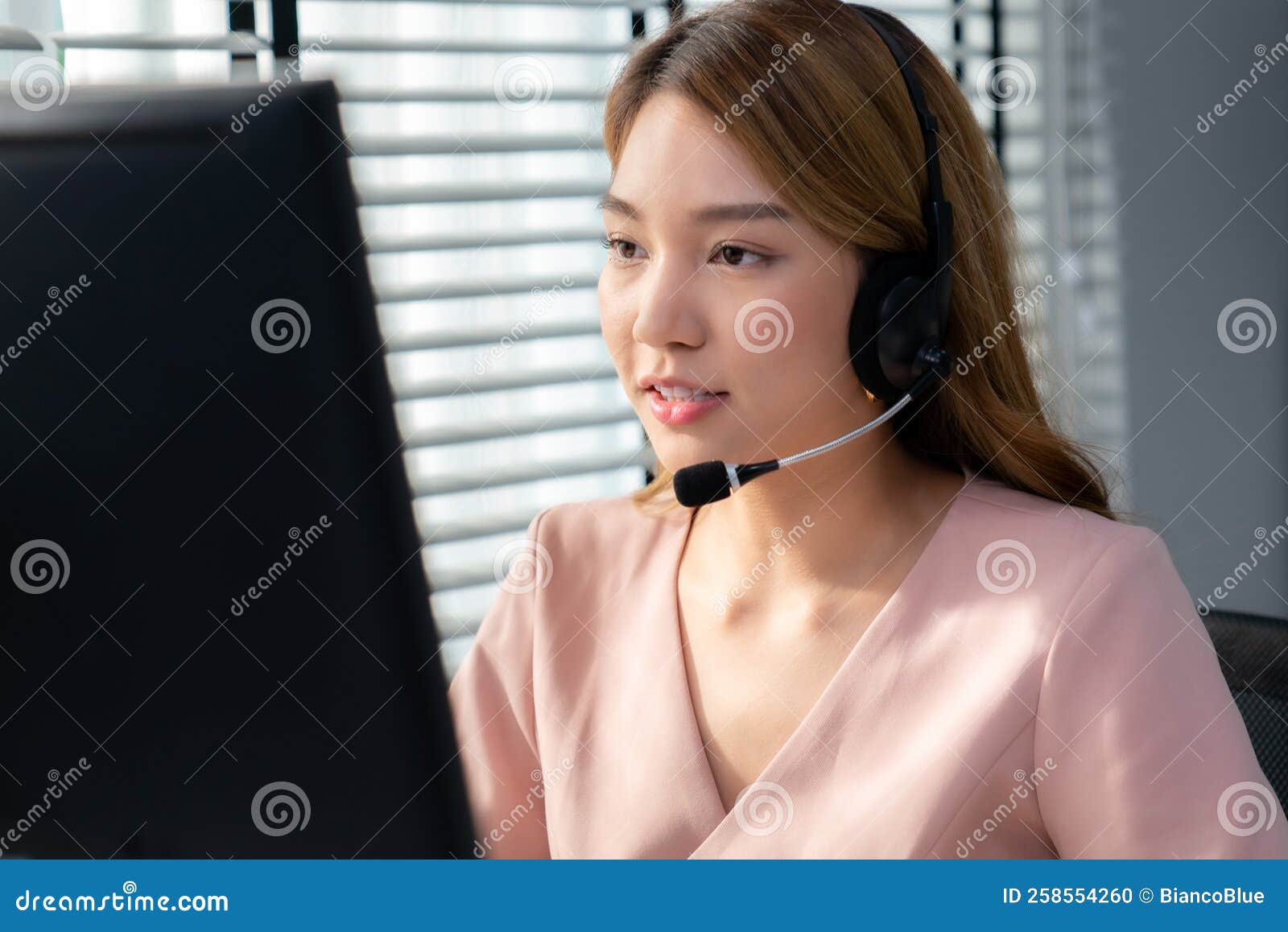 Competent Female Operator Working on Computer and while Talking with ...