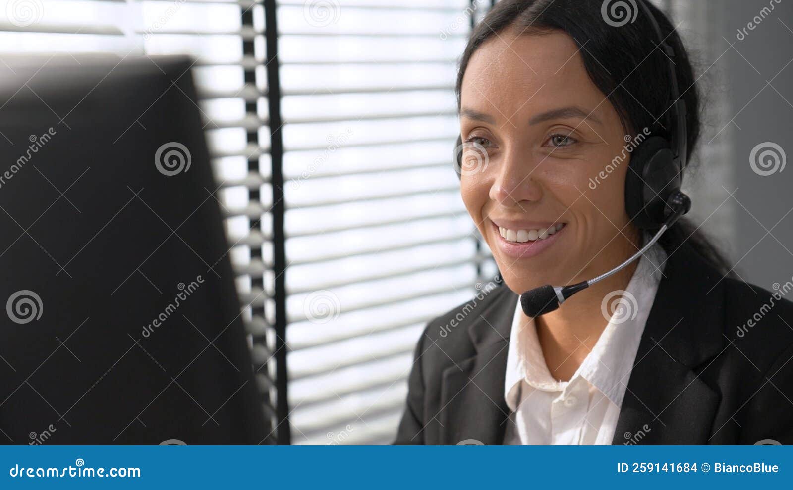 Competent Female Operator Working on Computer and while Talking with ...