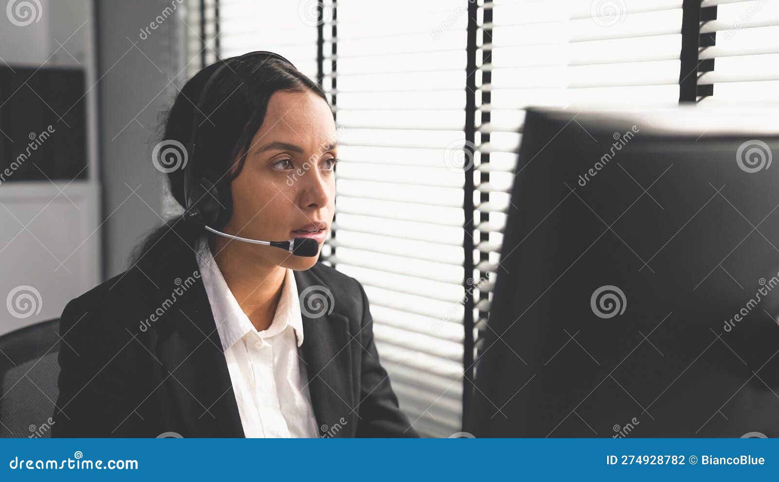 Competent Female Operator Working on Computer and while Talking with ...