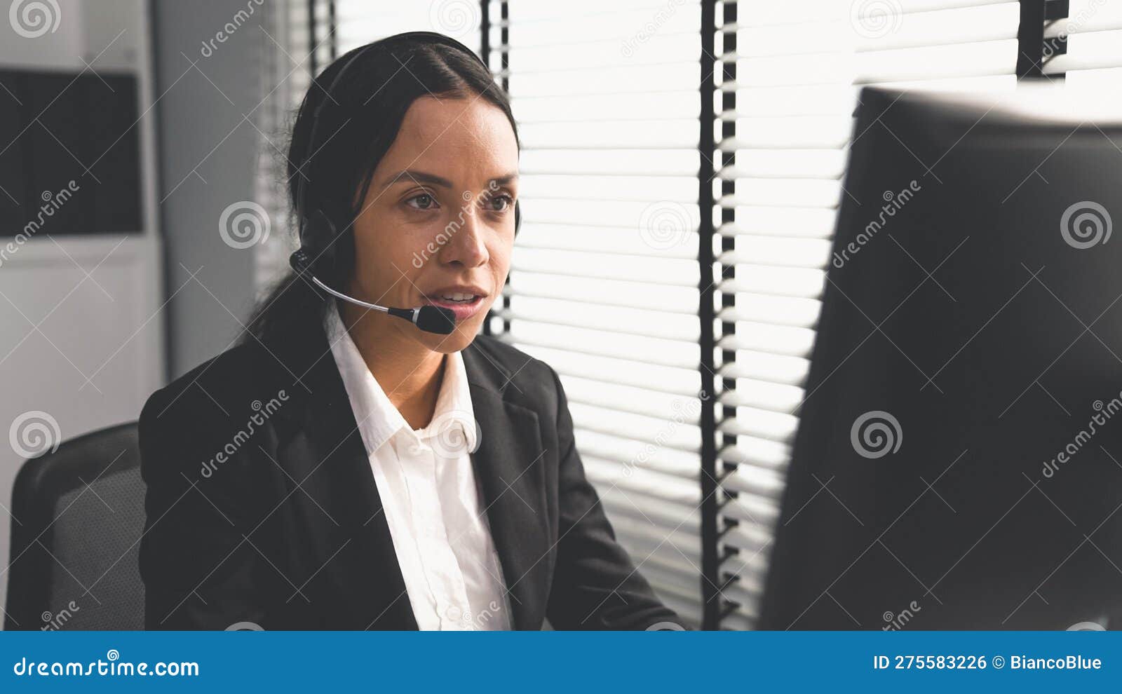 Competent Female Operator Working on Computer and while Talking with ...