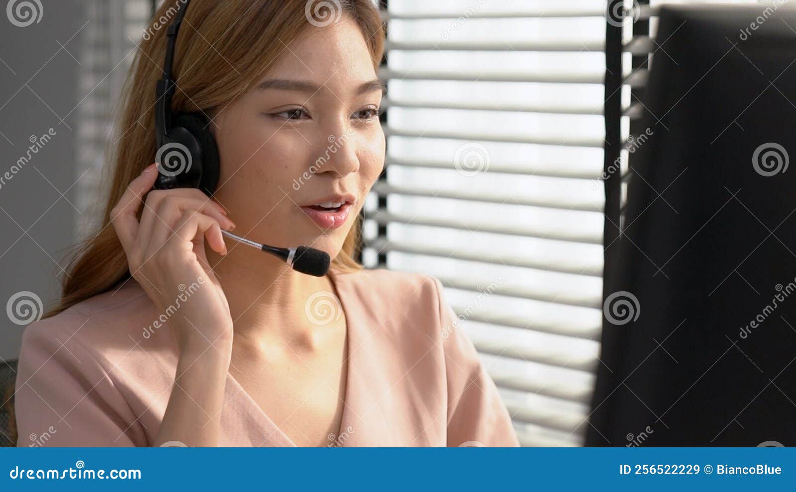 Competent Female Operator Working on Computer and while Talking with ...