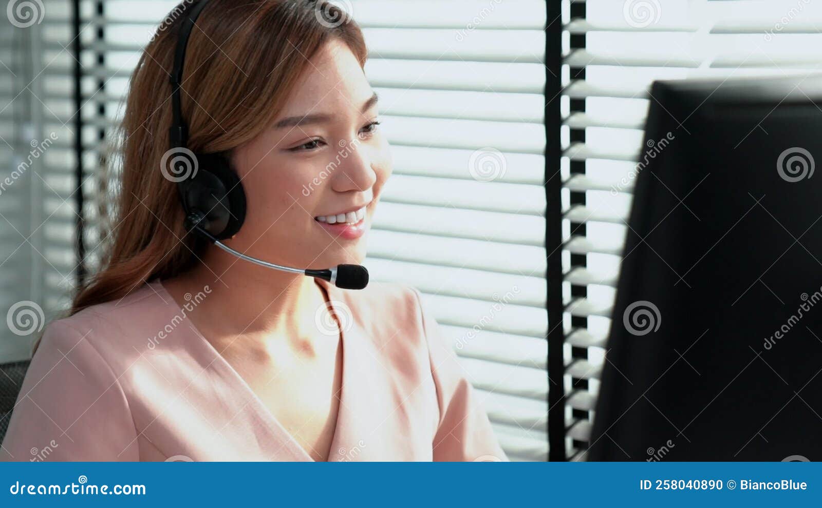 Competent Female Operator Working on Computer and while Talking with ...