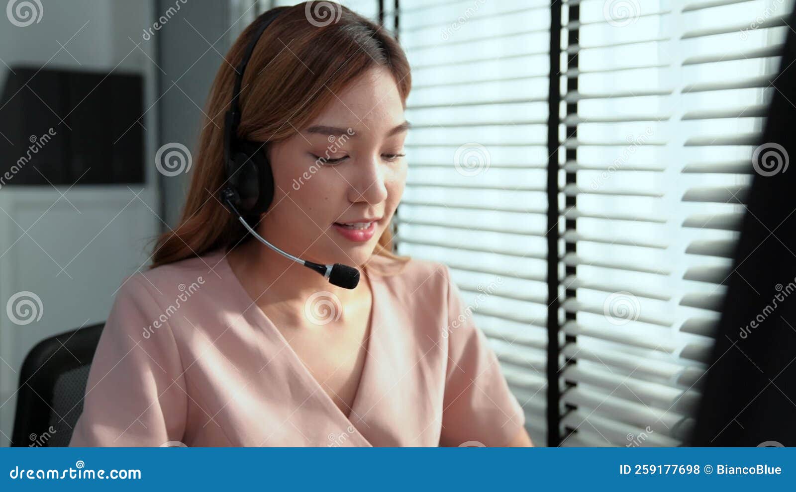 Competent Female Operator Working on Computer and while Talking with ...