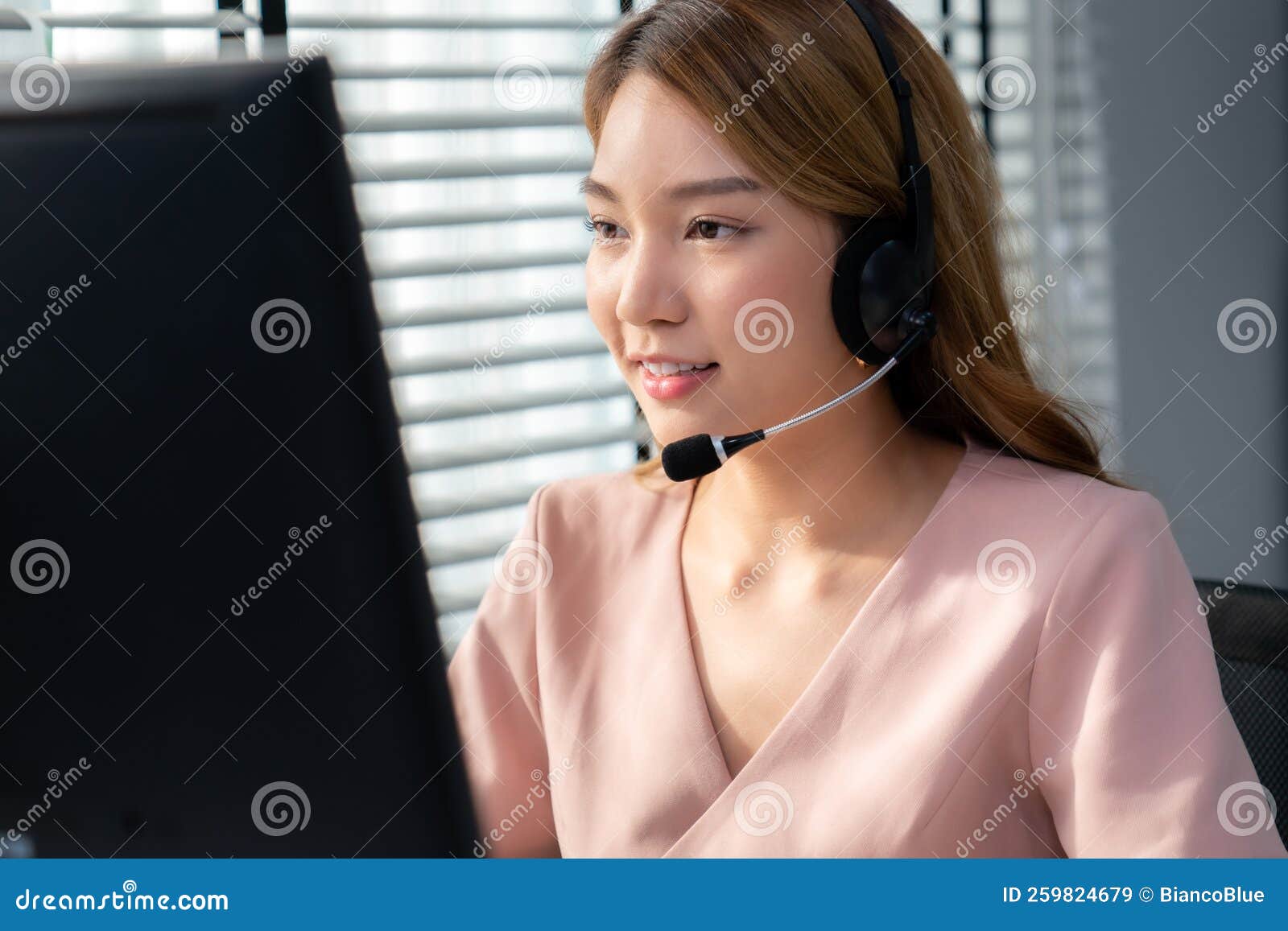 Competent Female Operator Working on Computer and while Talking with ...