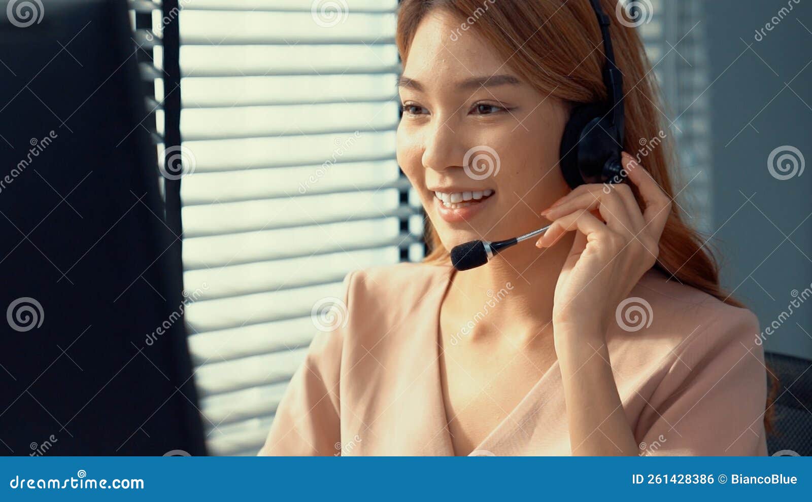 Competent Female Operator Working on Computer and while Talking with ...