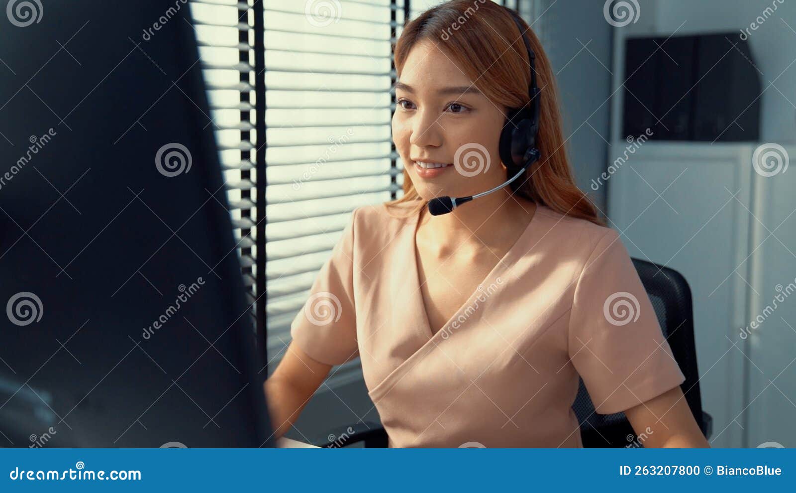 Competent Female Operator Working on Computer and while Talking with ...