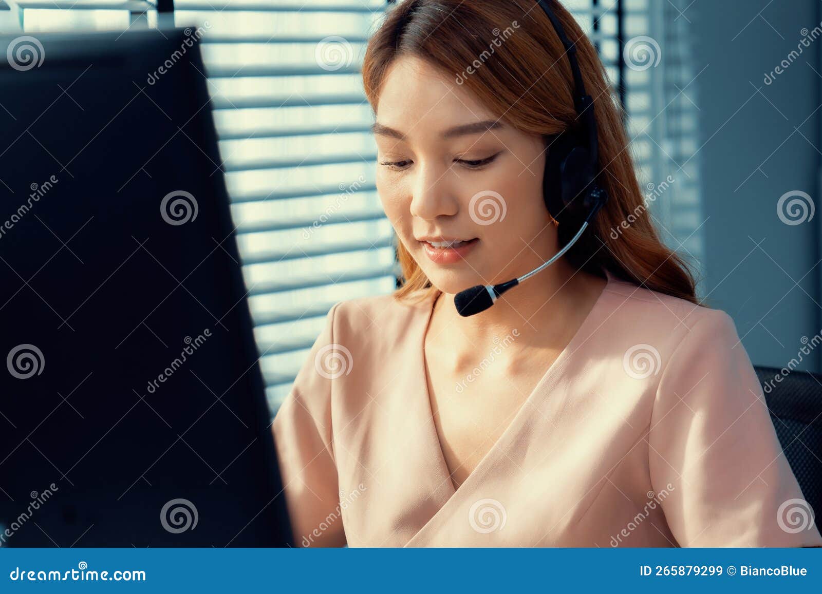 Competent Female Operator Working on Computer and while Talking with ...