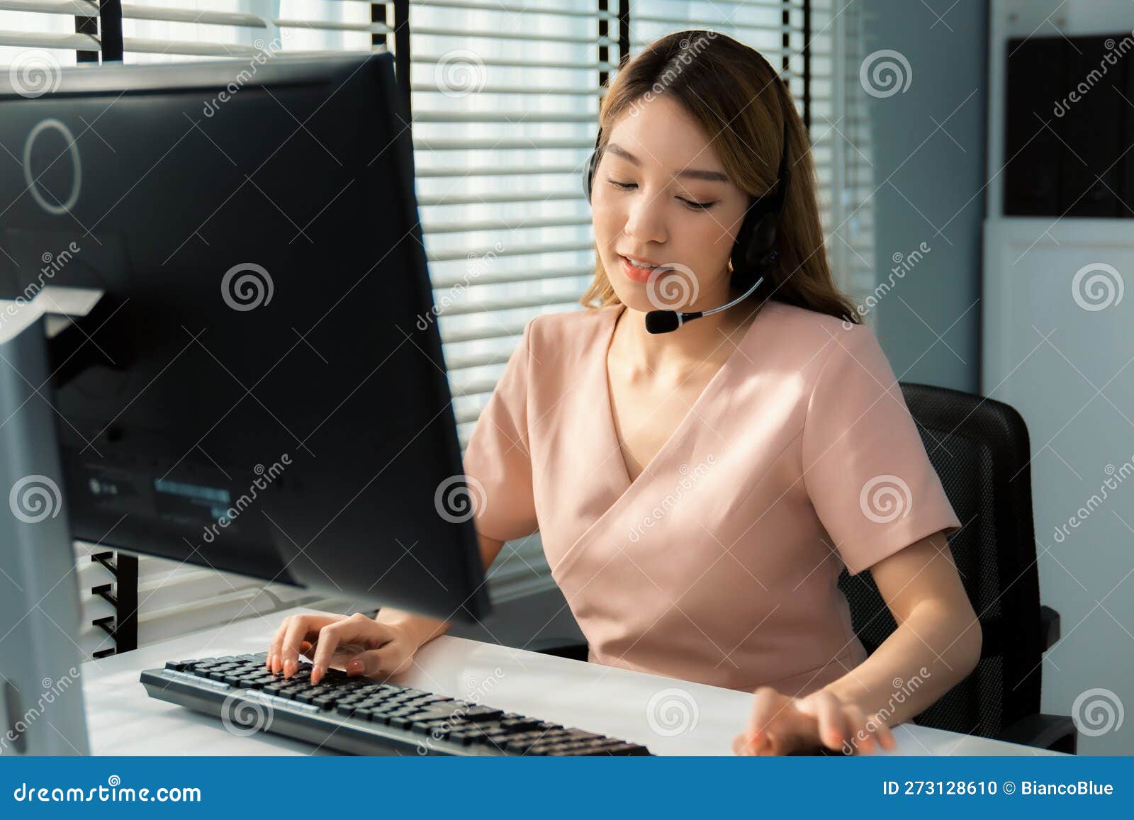 Competent Female Operator Working on Computer and while Talking with ...