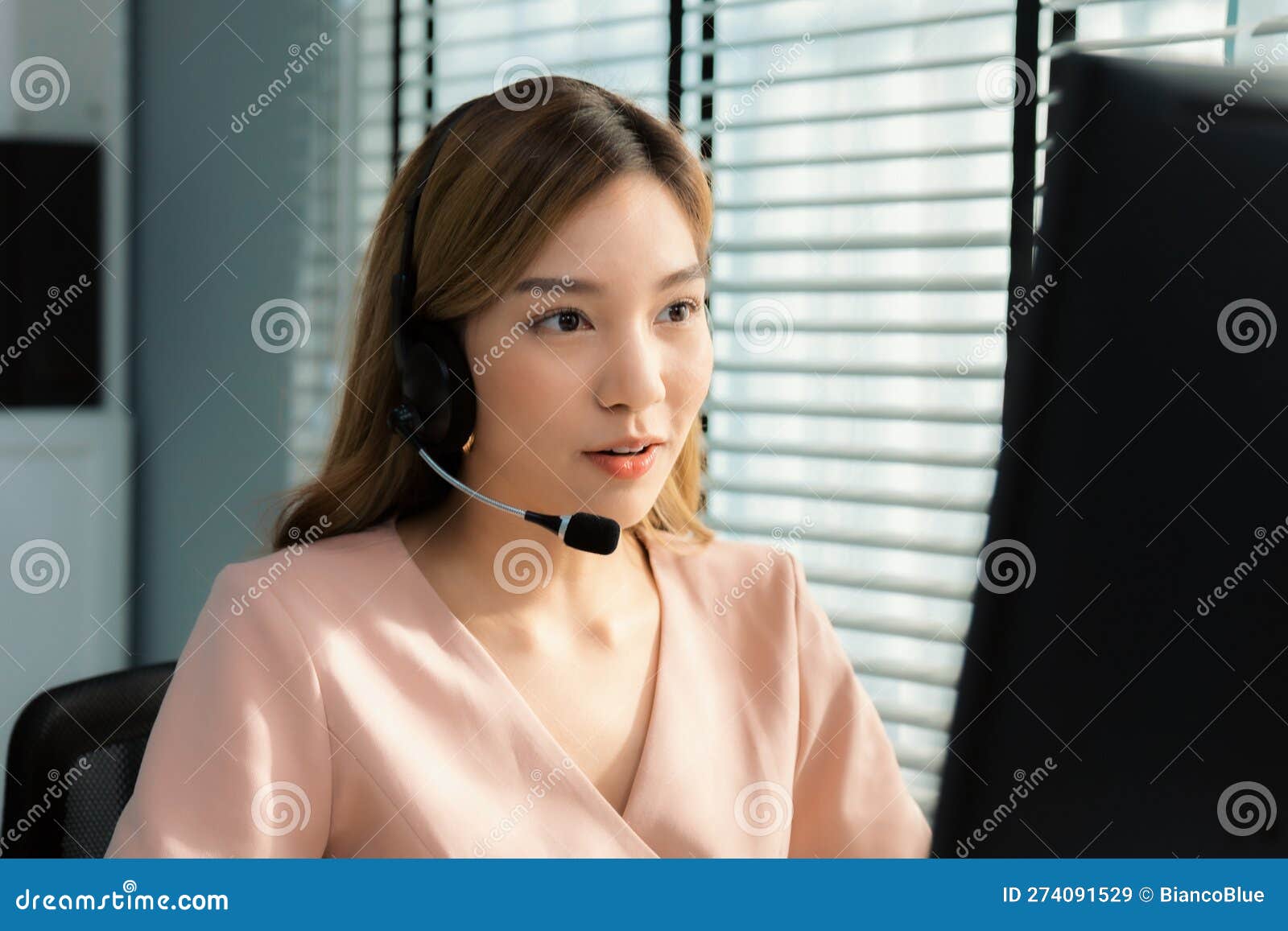 Competent Female Operator Working on Computer and while Talking with ...