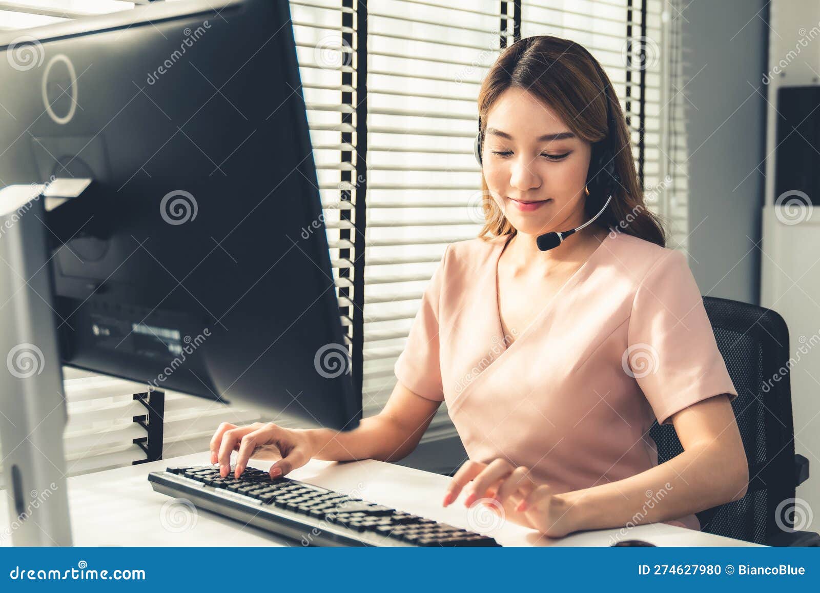 Competent Female Operator Working on Computer and while Talking with ...
