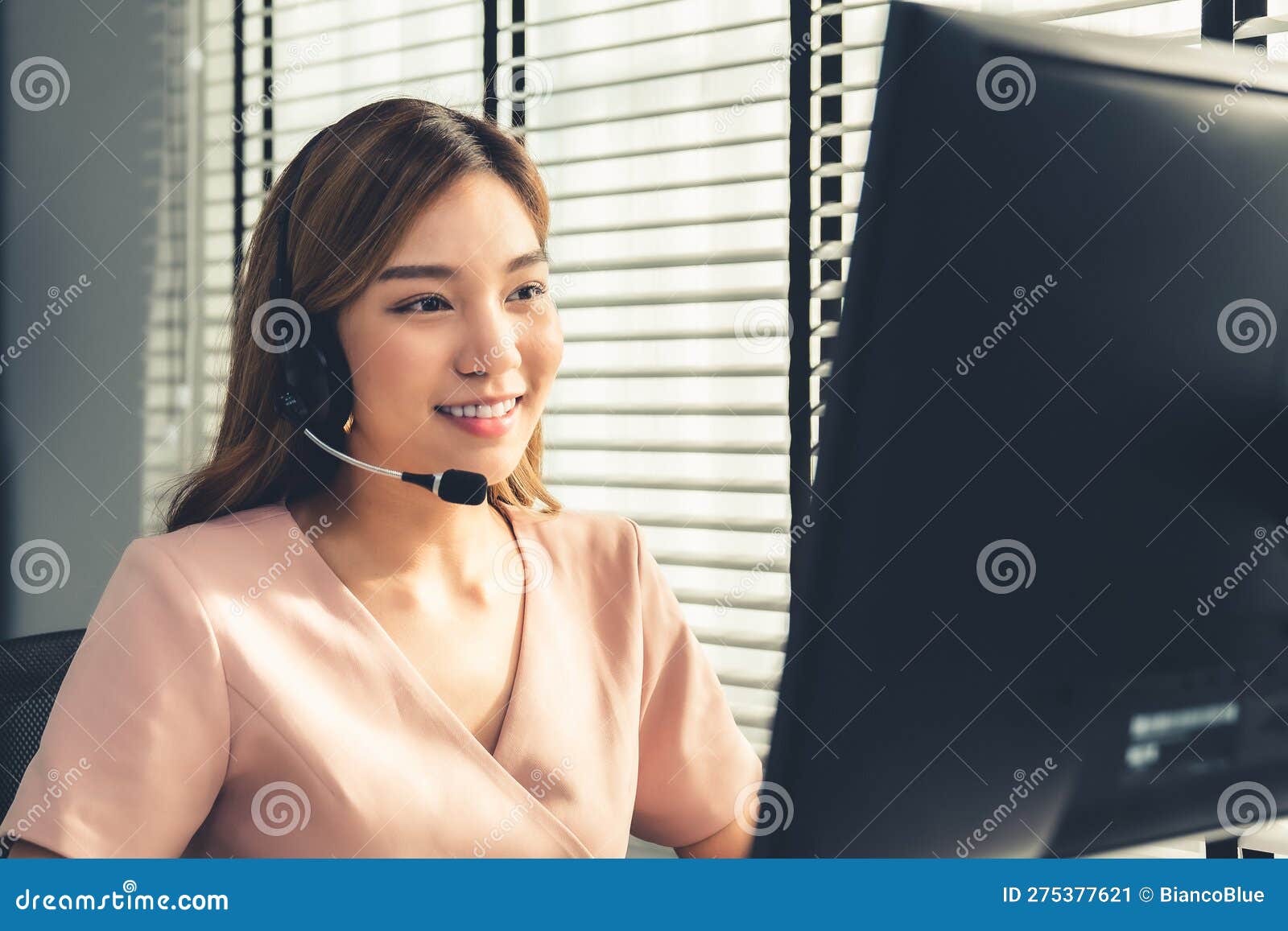 Competent Female Operator Working on Computer and while Talking with ...