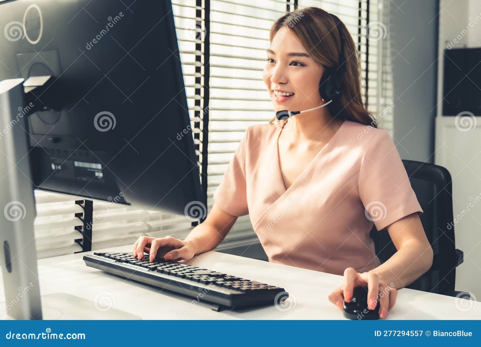 Competent Female Operator Working on Computer and while Talking with ...
