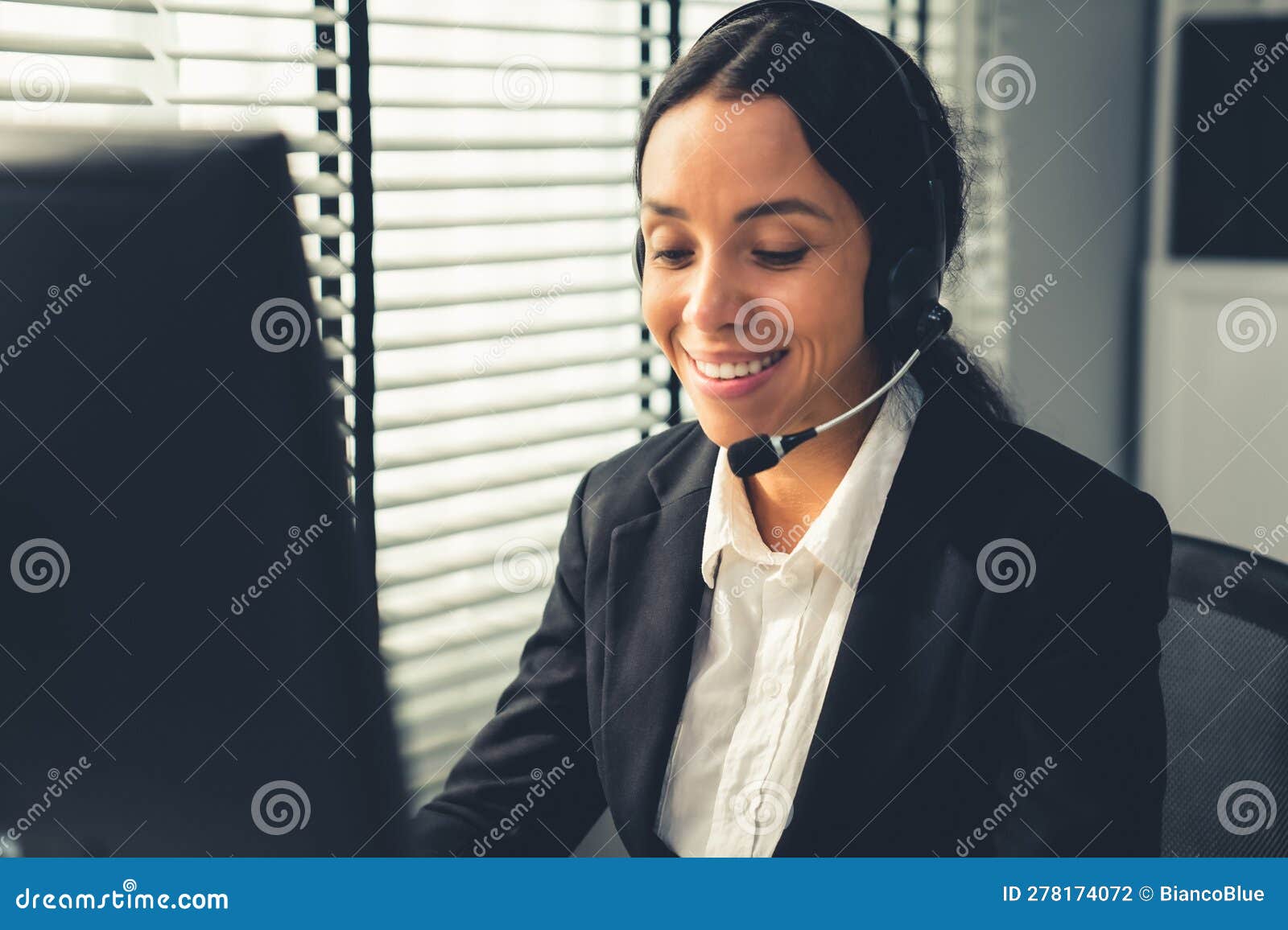 Competent Female Operator Working on Computer and while Talking with ...