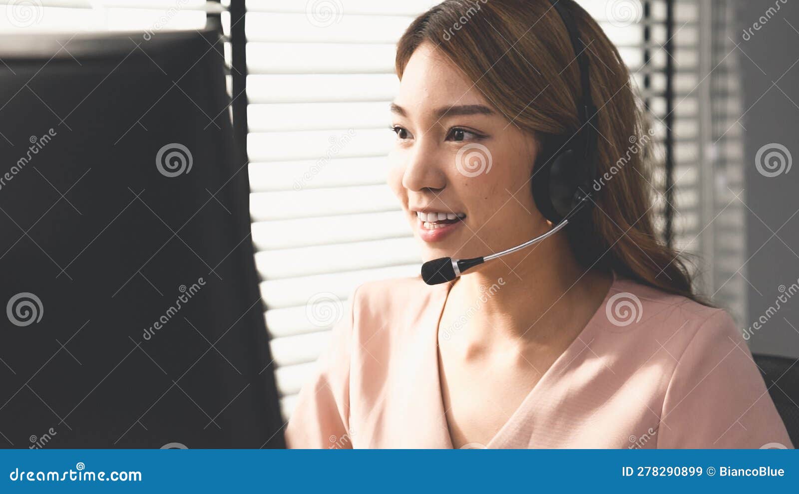 Competent Female Operator Working on Computer and while Talking with ...