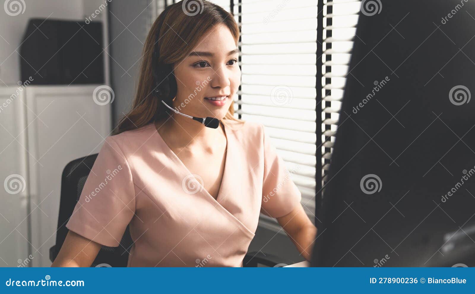 Competent Female Operator Working on Computer and while Talking with ...