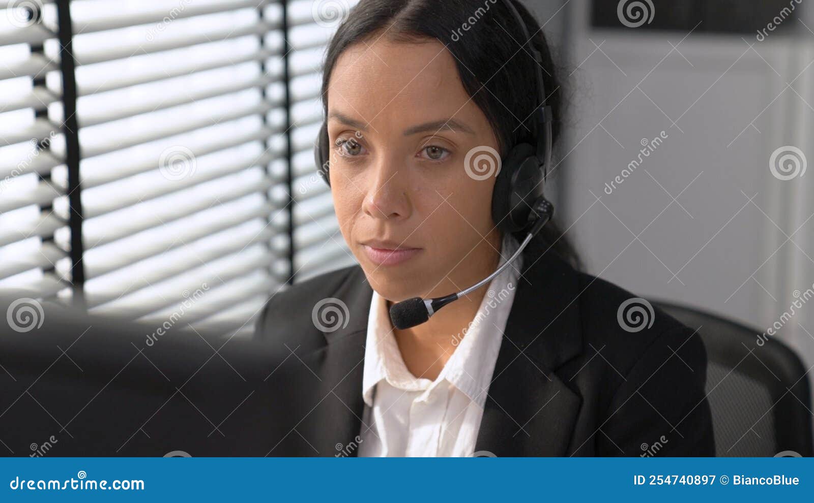 Competent Female Operator Working on Computer and while Talking with ...