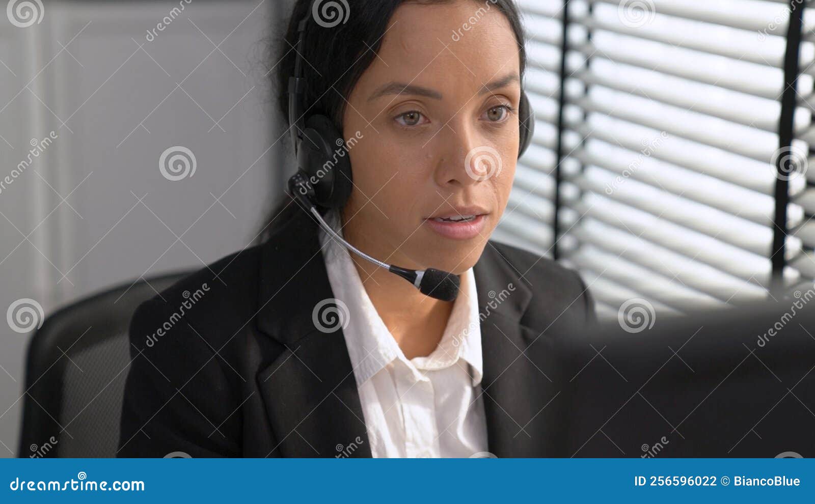 Competent Female Operator Working on Computer and while Talking with ...