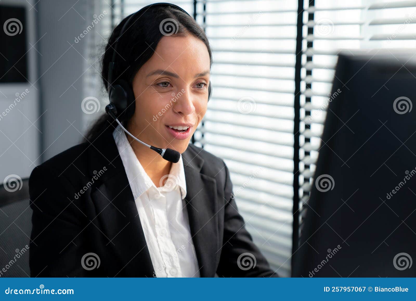 Competent Female Operator Working on Computer and while Talking with ...