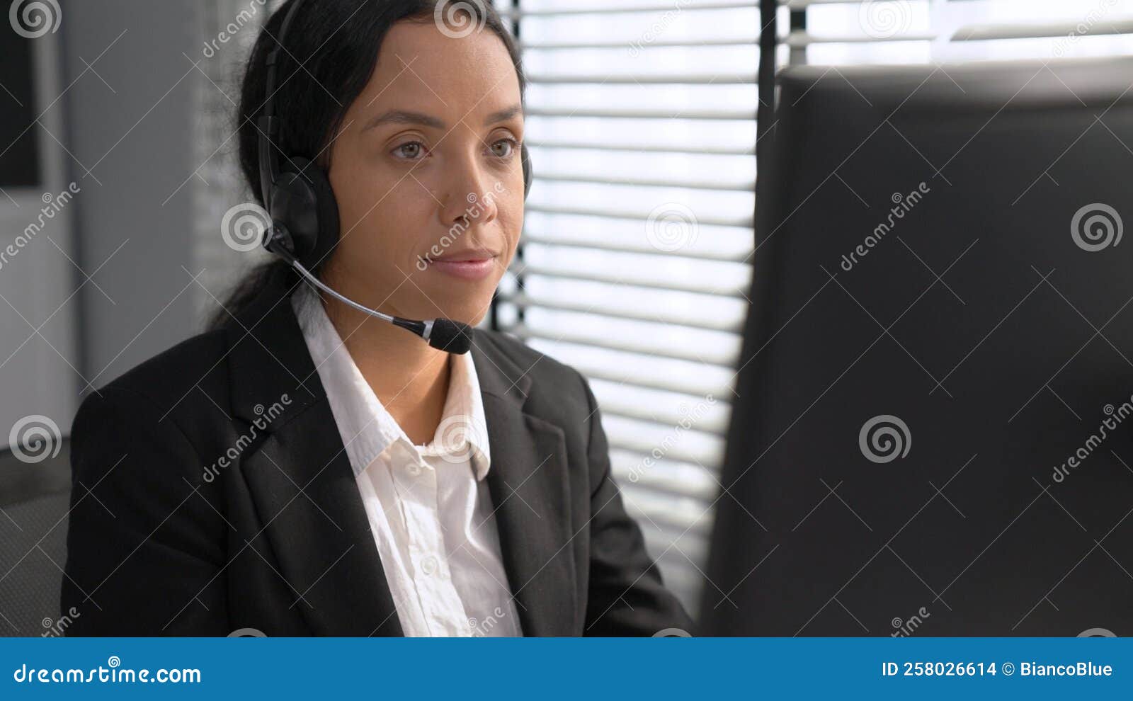Competent Female Operator Working on Computer and while Talking with ...