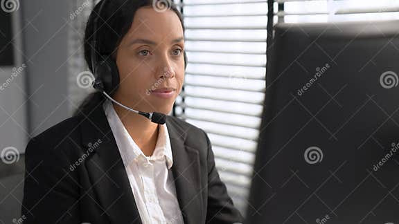 Competent Female Operator Working on Computer and while Talking with ...