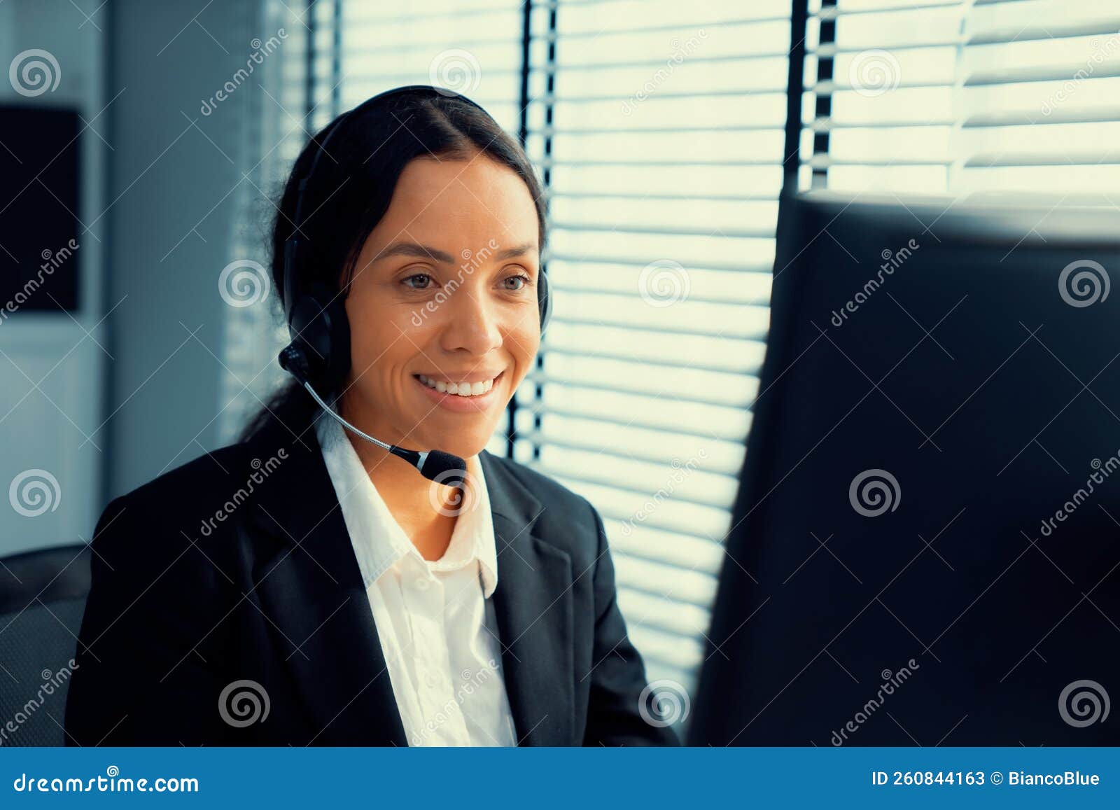 Competent Female Operator Working on Computer and while Talking with ...