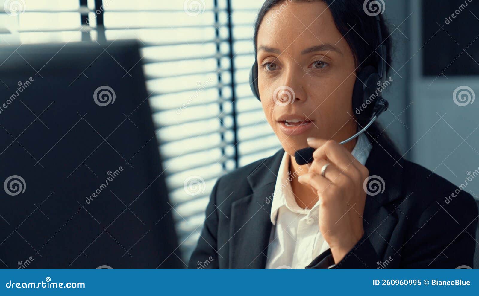 Competent Female Operator Working on Computer and while Talking with ...
