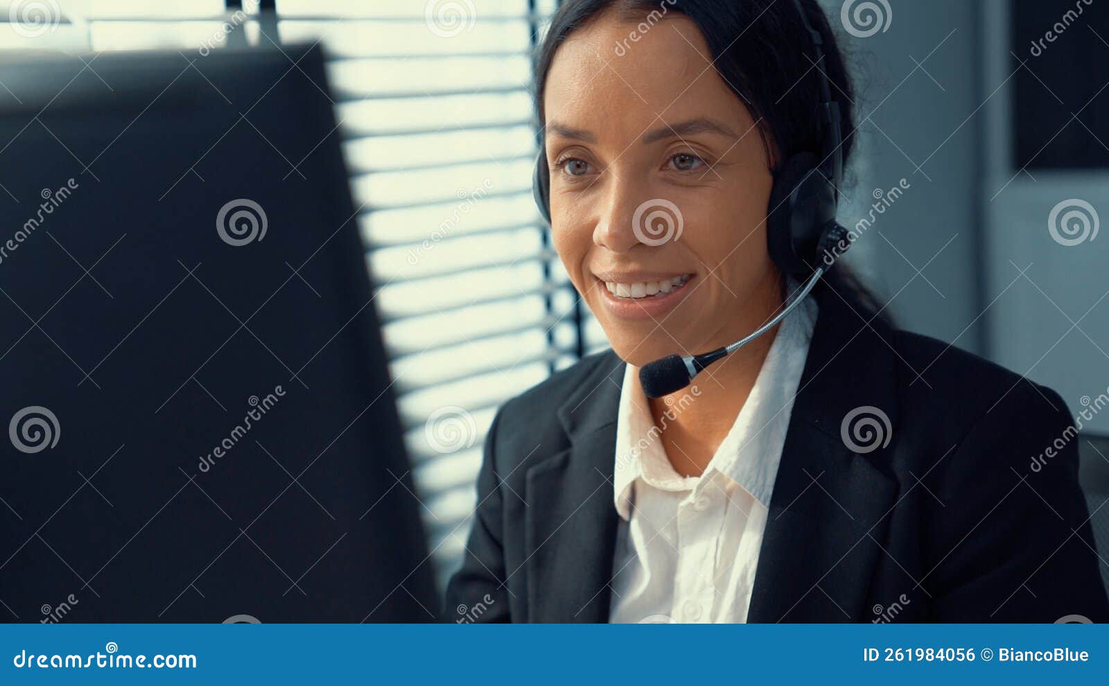 Competent Female Operator Working on Computer and while Talking with ...