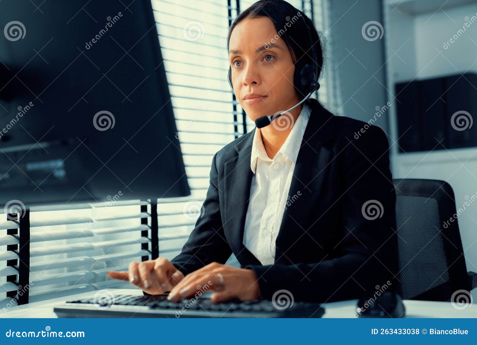 Competent Female Operator Working on Computer and while Talking with ...