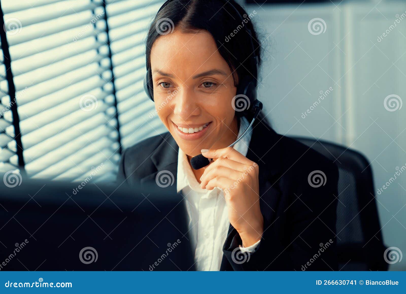 Competent Female Operator Working on Computer and while Talking with ...