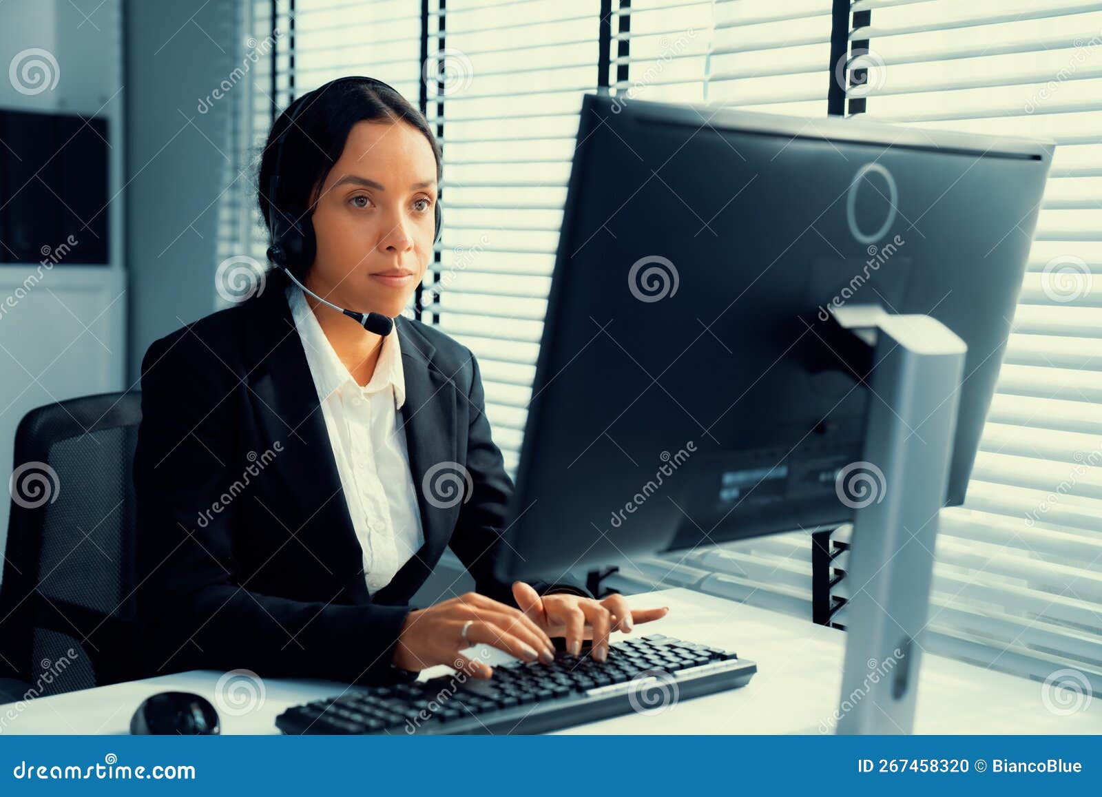 Competent Female Operator Working on Computer and while Talking with ...