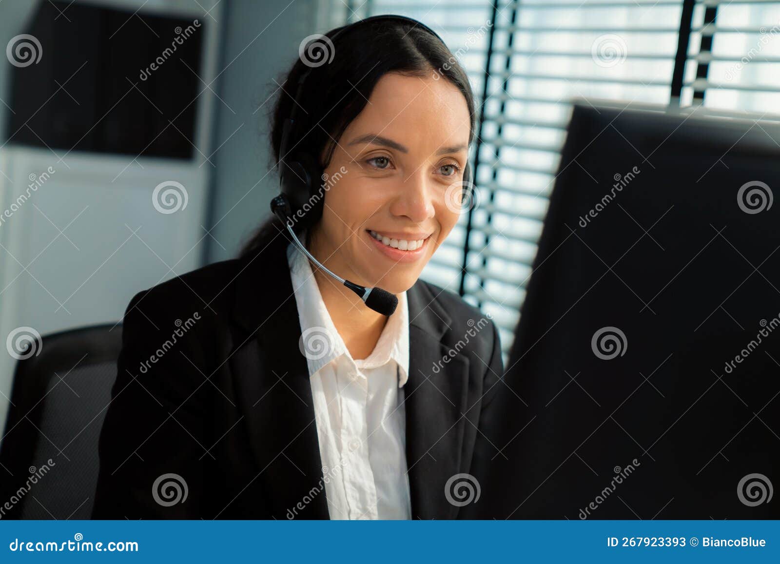 Competent Female Operator Working on Computer and while Talking with ...