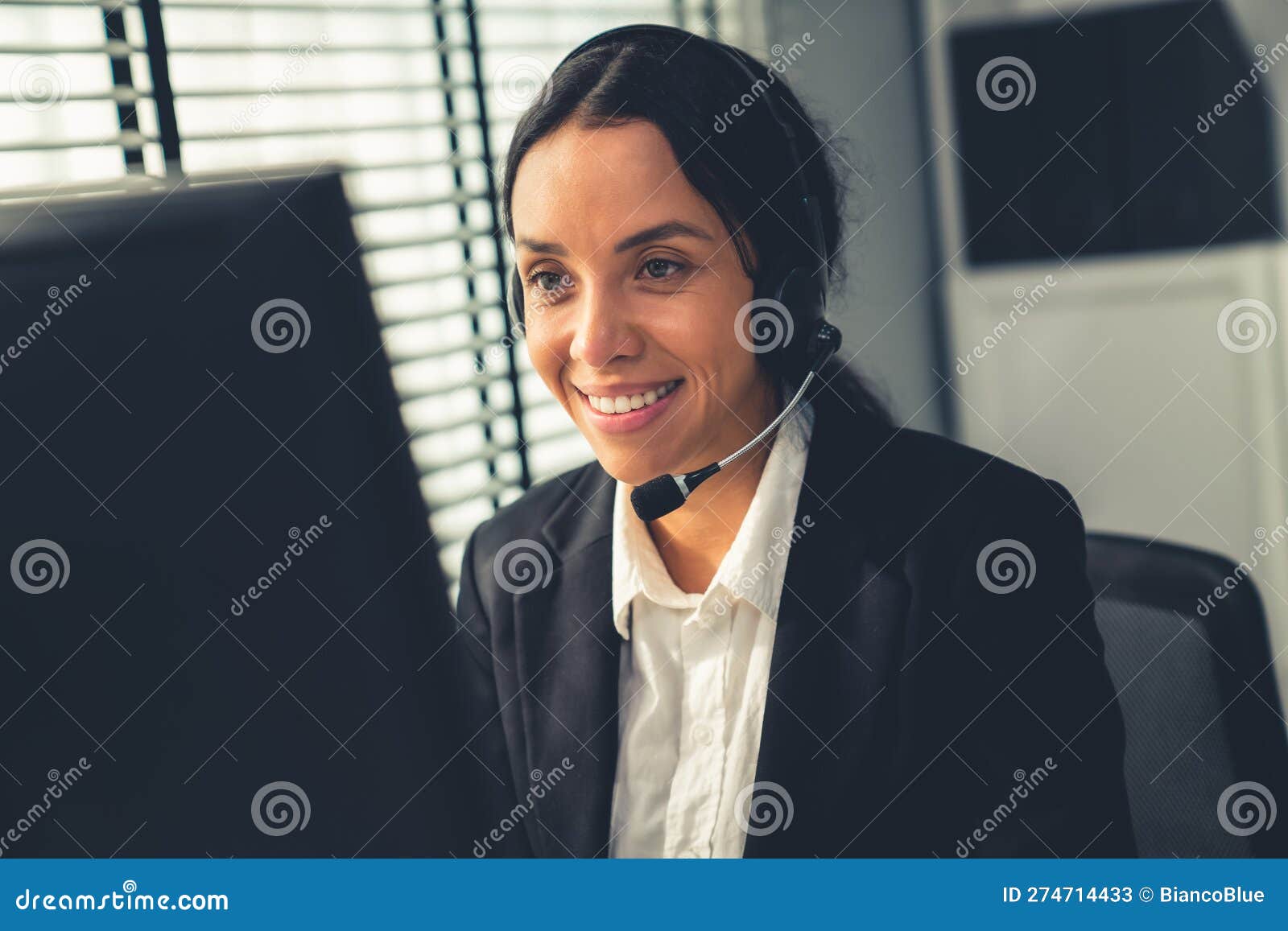 Competent Female Operator Working on Computer and while Talking with ...