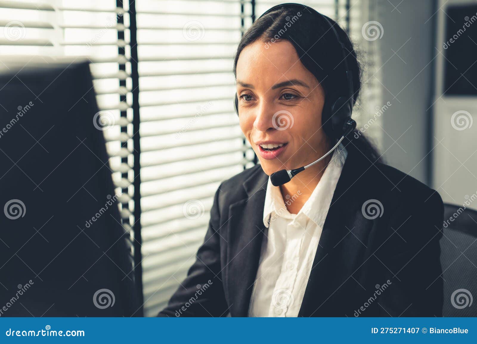 Competent Female Operator Working on Computer and while Talking with ...