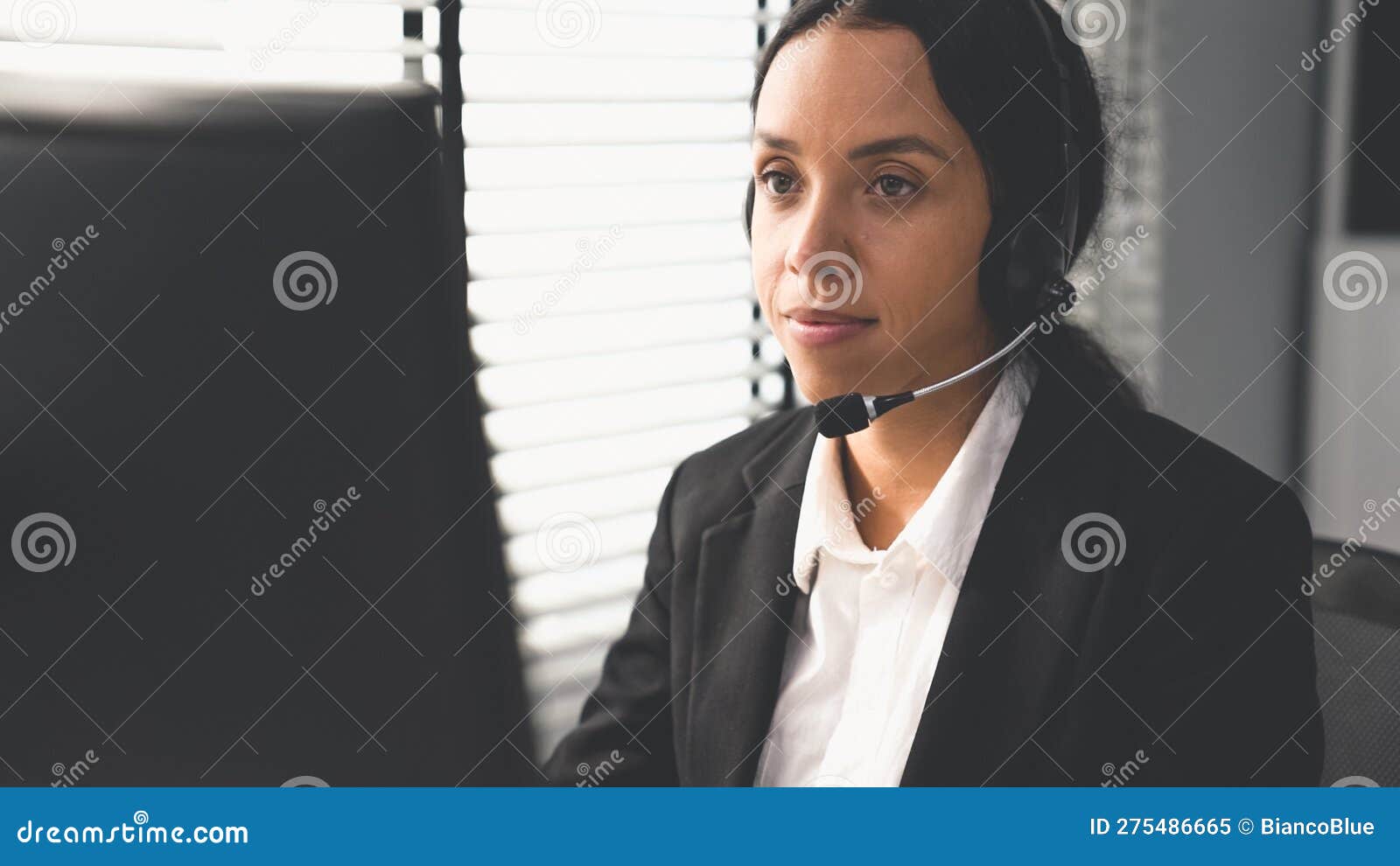 Competent Female Operator Working on Computer and while Talking with ...