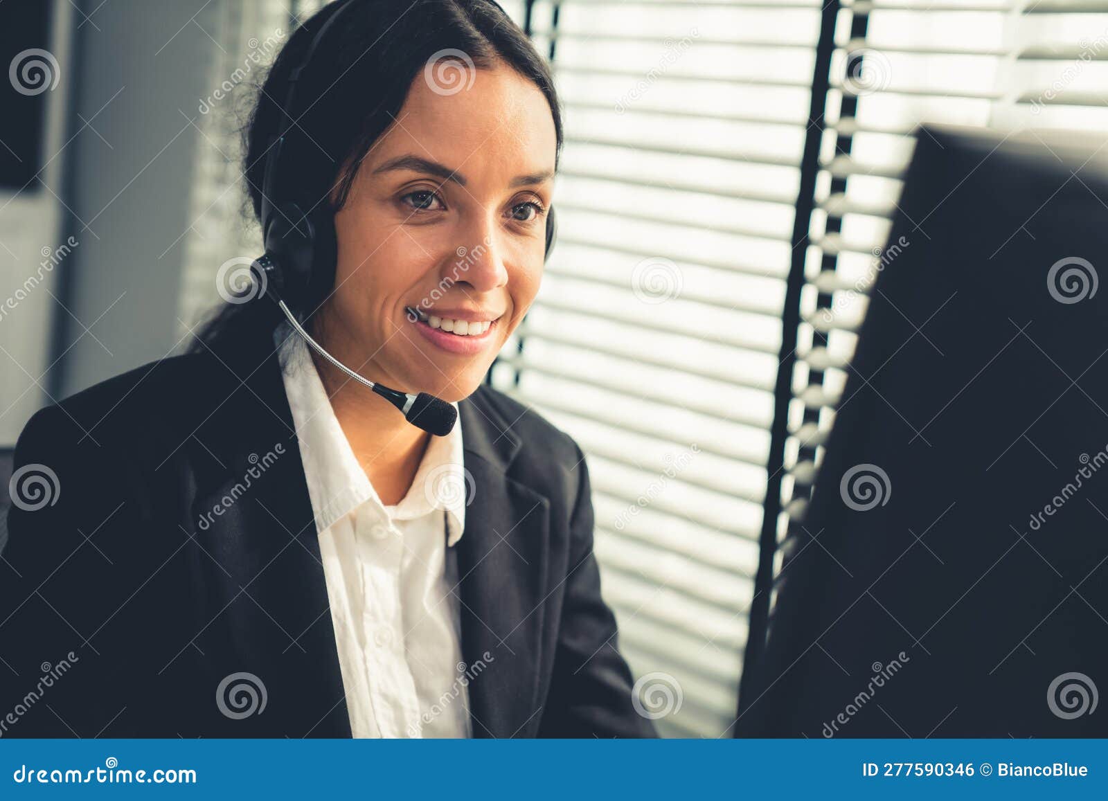 Competent Female Operator Working on Computer and while Talking with ...