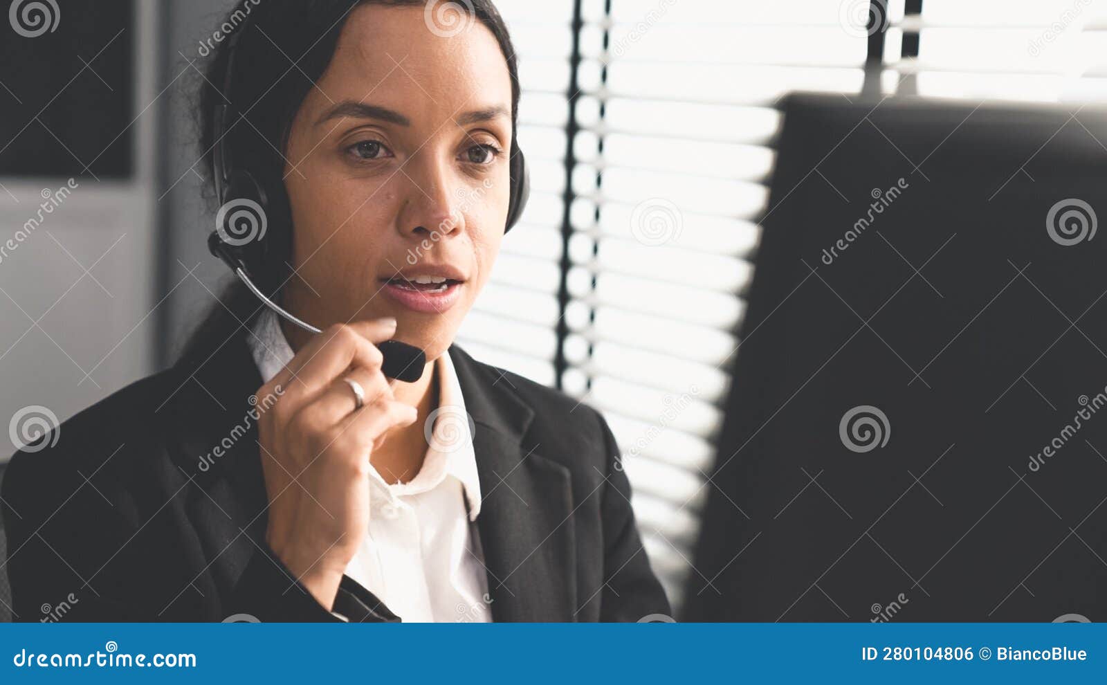 Competent Female Operator Working on Computer and while Talking with ...