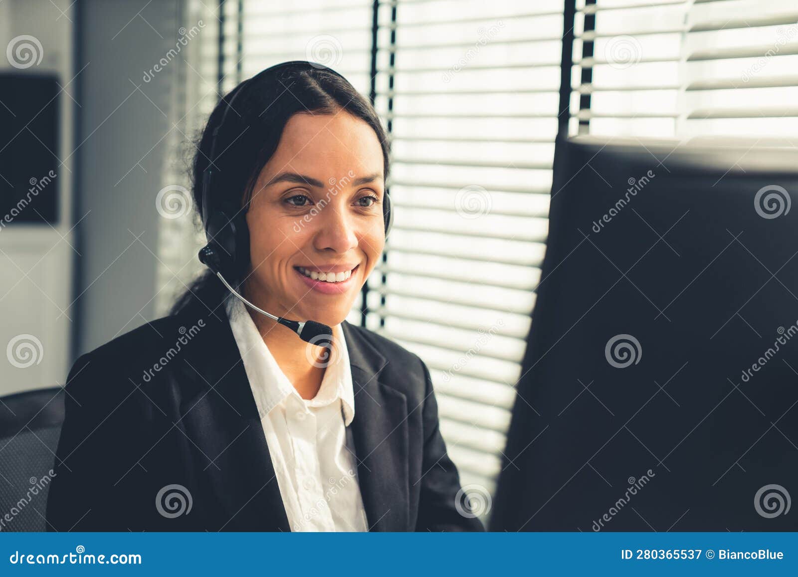 Competent Female Operator Working on Computer and while Talking with ...