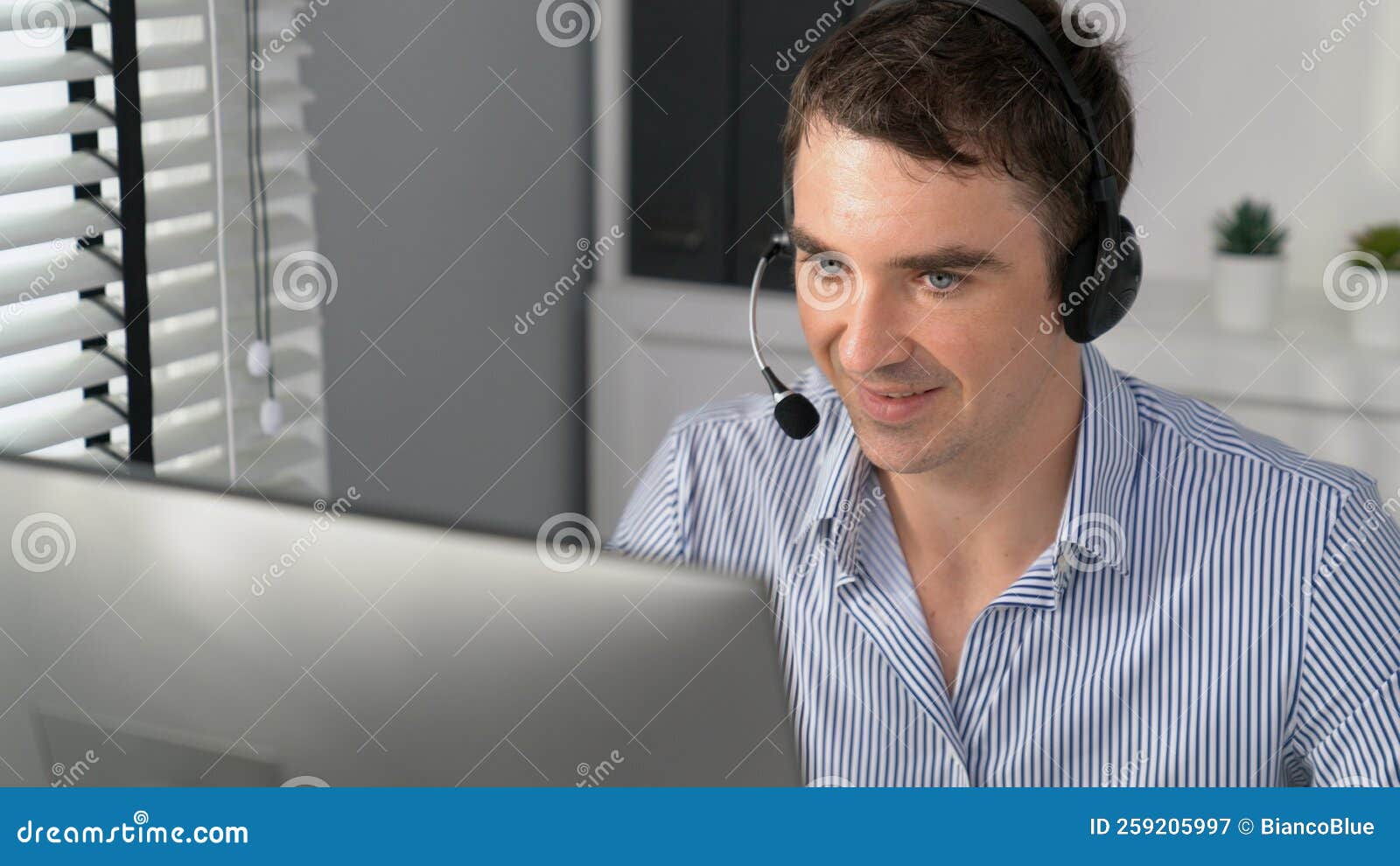 Competent Male Operator Working with Customers in the Office. Stock ...