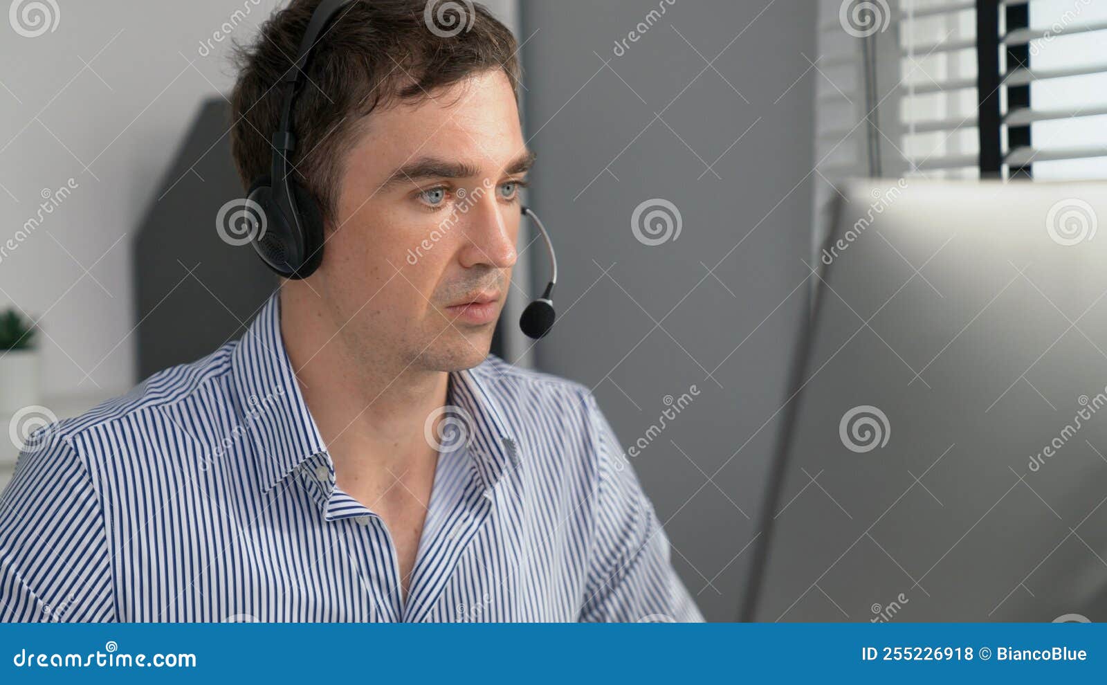 Competent Male Operator Working with Customers in the Office. Stock ...
