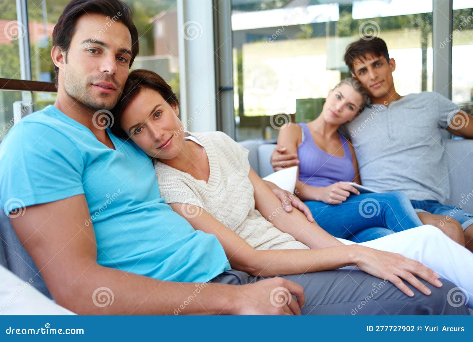 Complete Contentment. Two Couples Sitting Contently on a Sofa. Stock ...